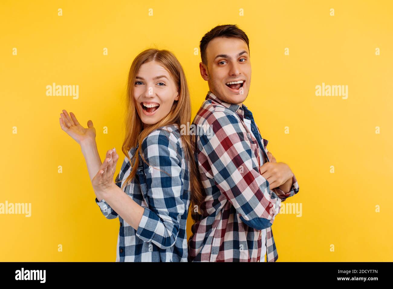 Young Couple Man And Woman Clap Their Hands And Applaud On Yellow