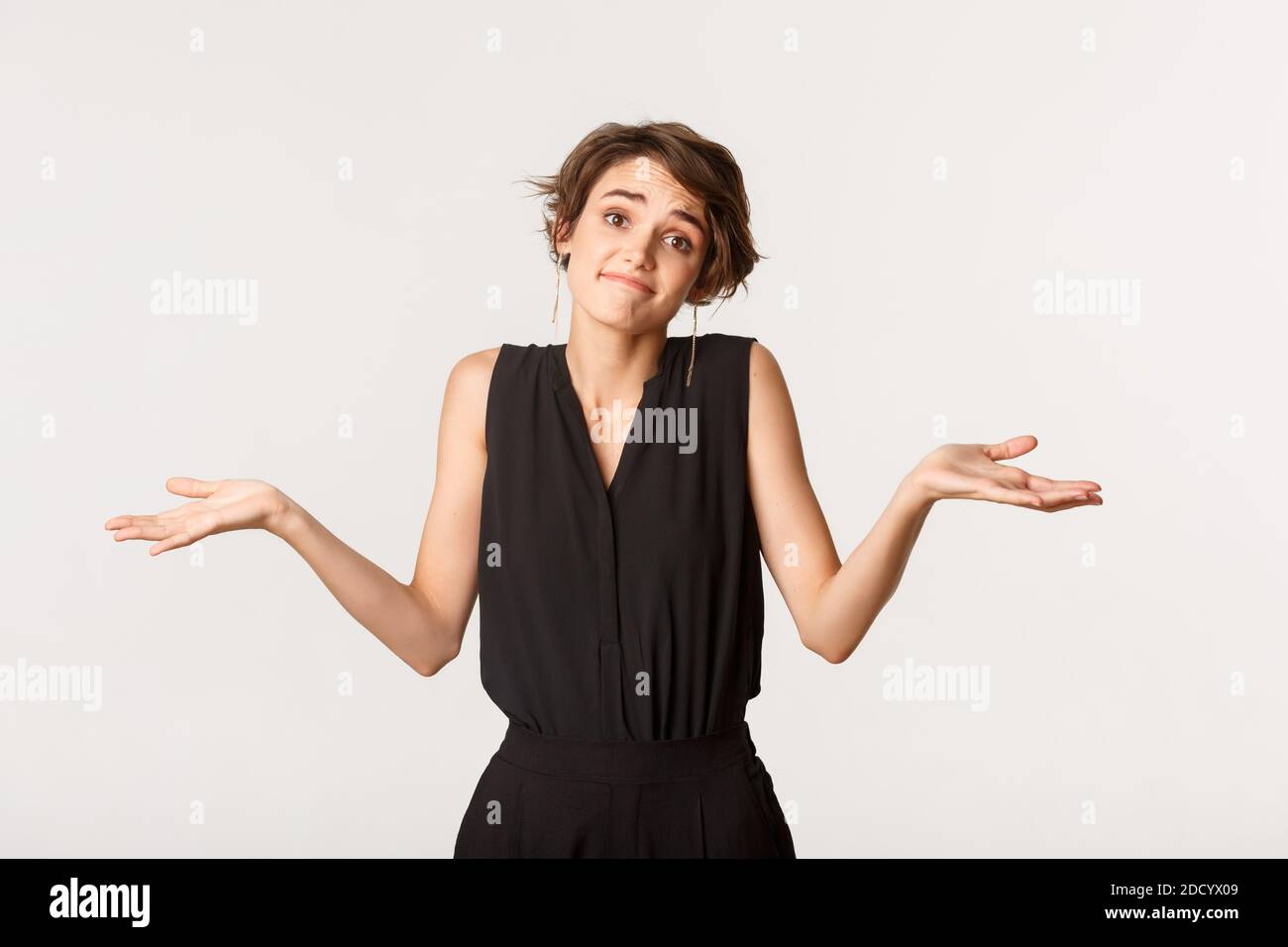 Clueless young woman apologizing for being unaware, shrugging with ...