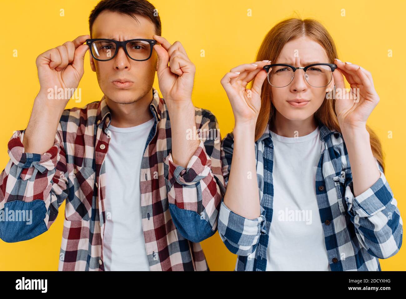 young people, man and woman wearing glasses for vision on yellow ...