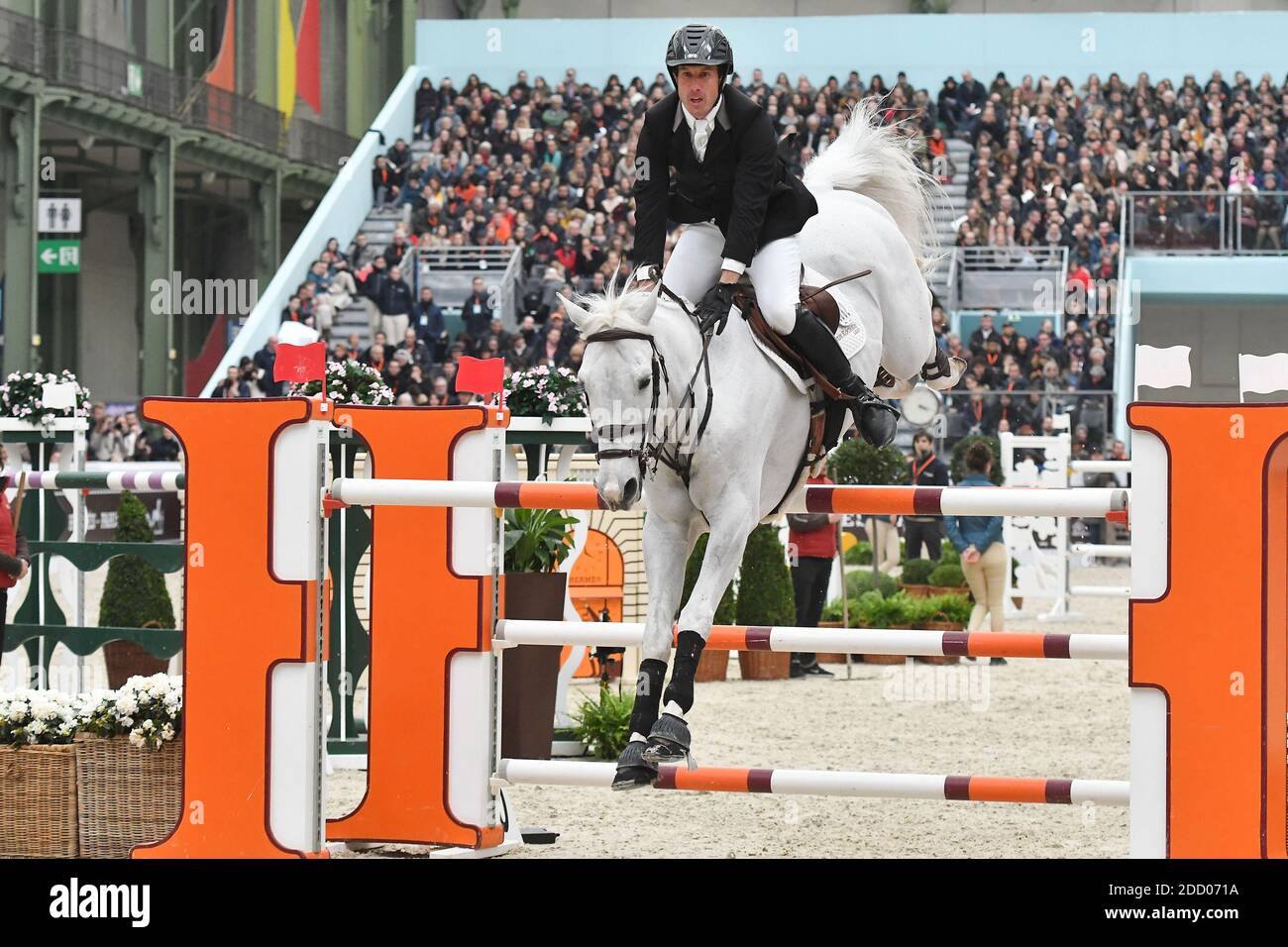 Andrew Kocher, of Usa, on Navalo De Poheton competes during the Saut ...