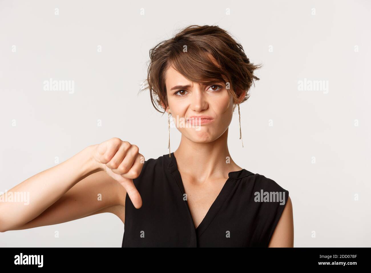 Disappointed elegant woman smirk and showing thumb-down, dislike and ...