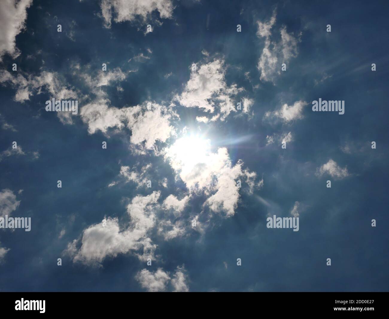 clouds blue sky sun ray natural background Stock Photo - Alamy