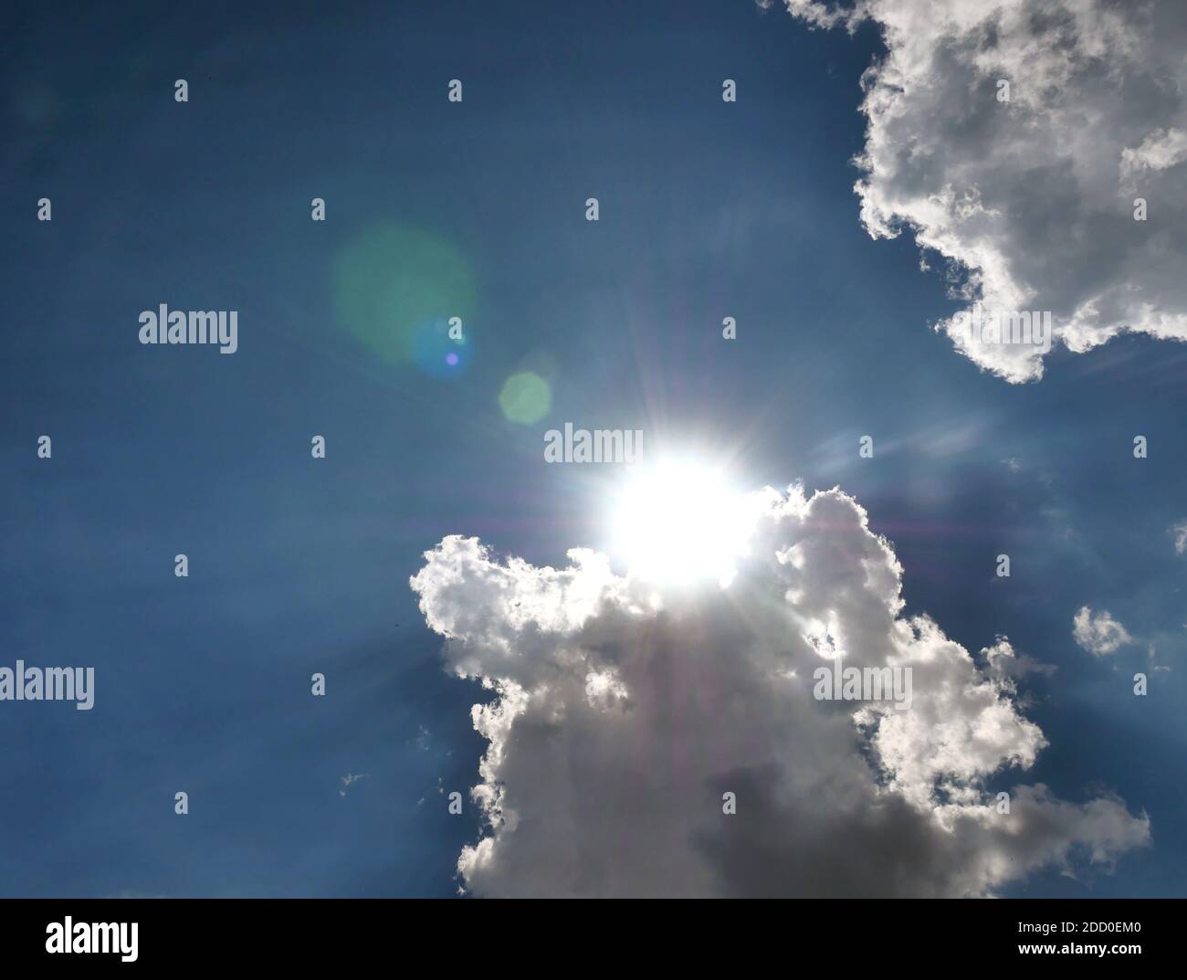 clouds blue sky sun ray natural background Stock Photo - Alamy