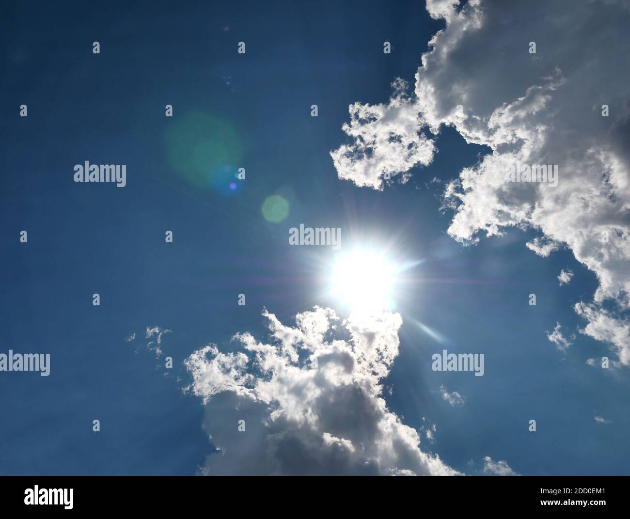 clouds blue sky sun ray natural background Stock Photo - Alamy