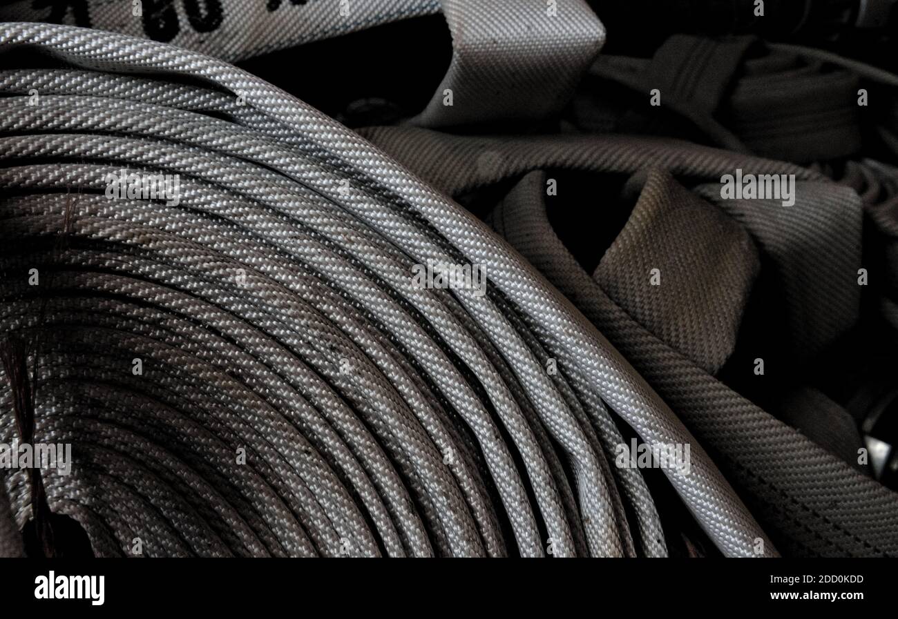 Fire fighter hose rolled up and ready for action. Close-up Stock Photo ...