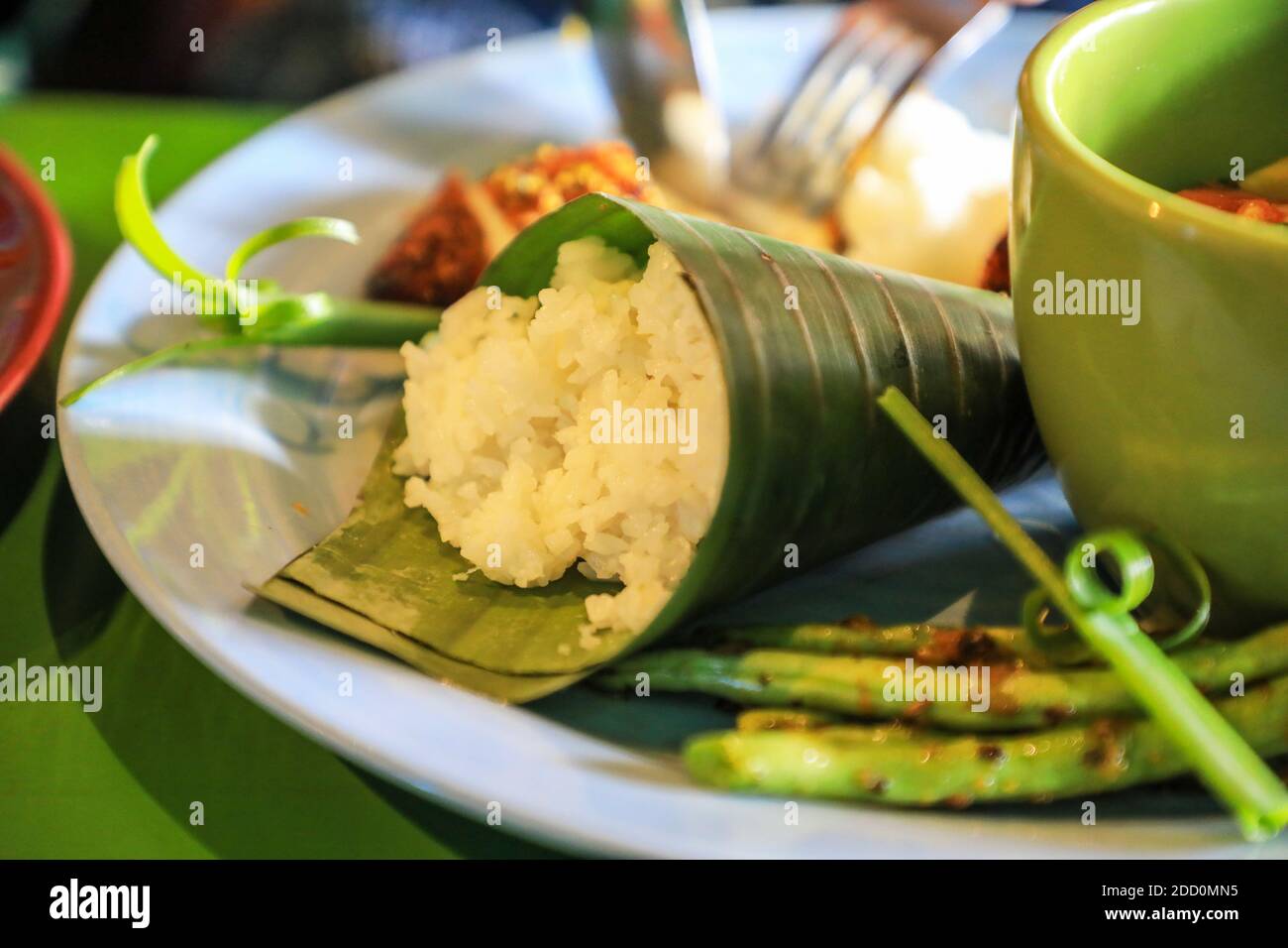 Cone of boiled rice wrapped in a banana leaf hi-res stock photography ...