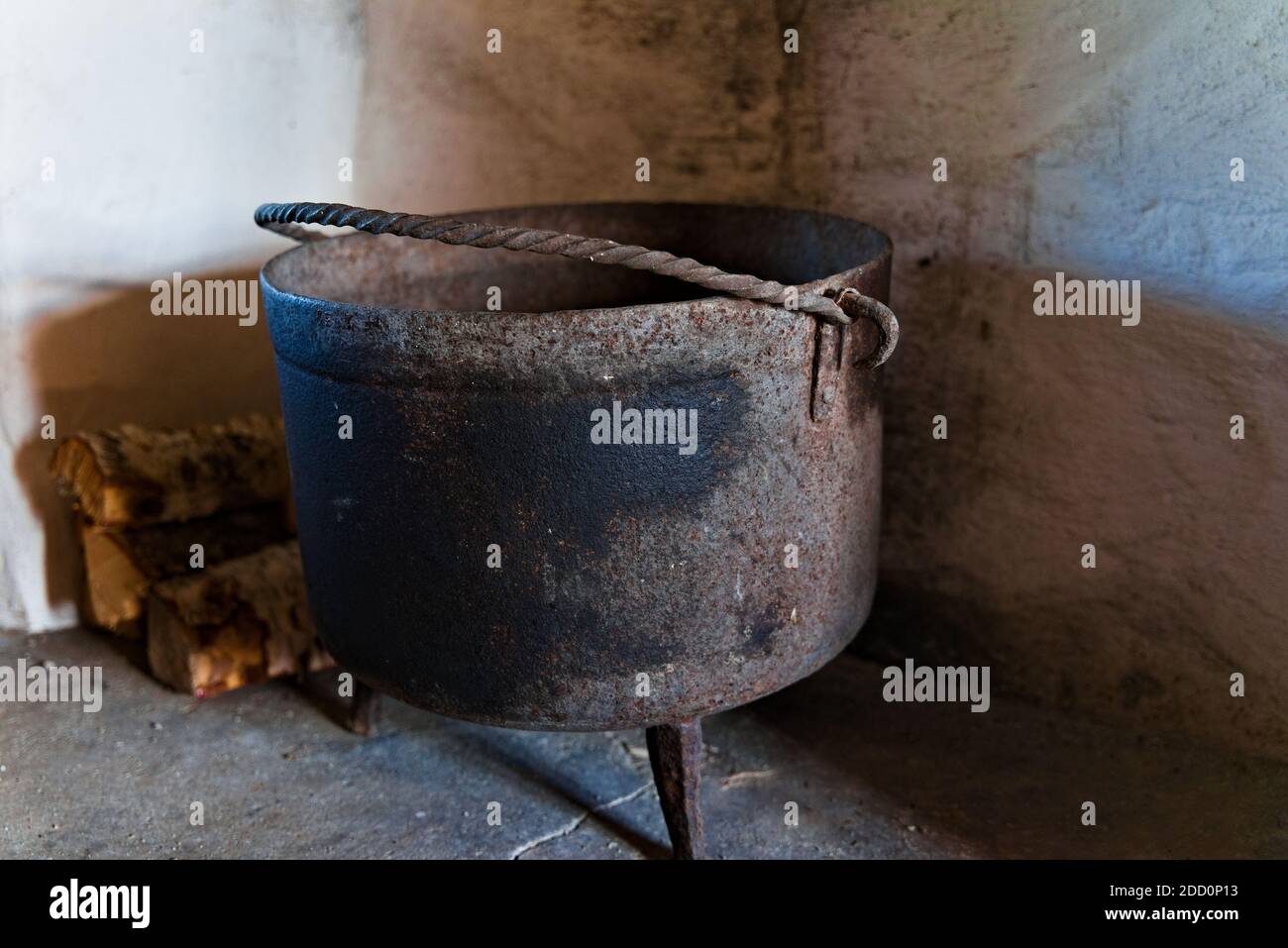 Medieval black cast iron pot on the fireplace Stock Photo - Alamy