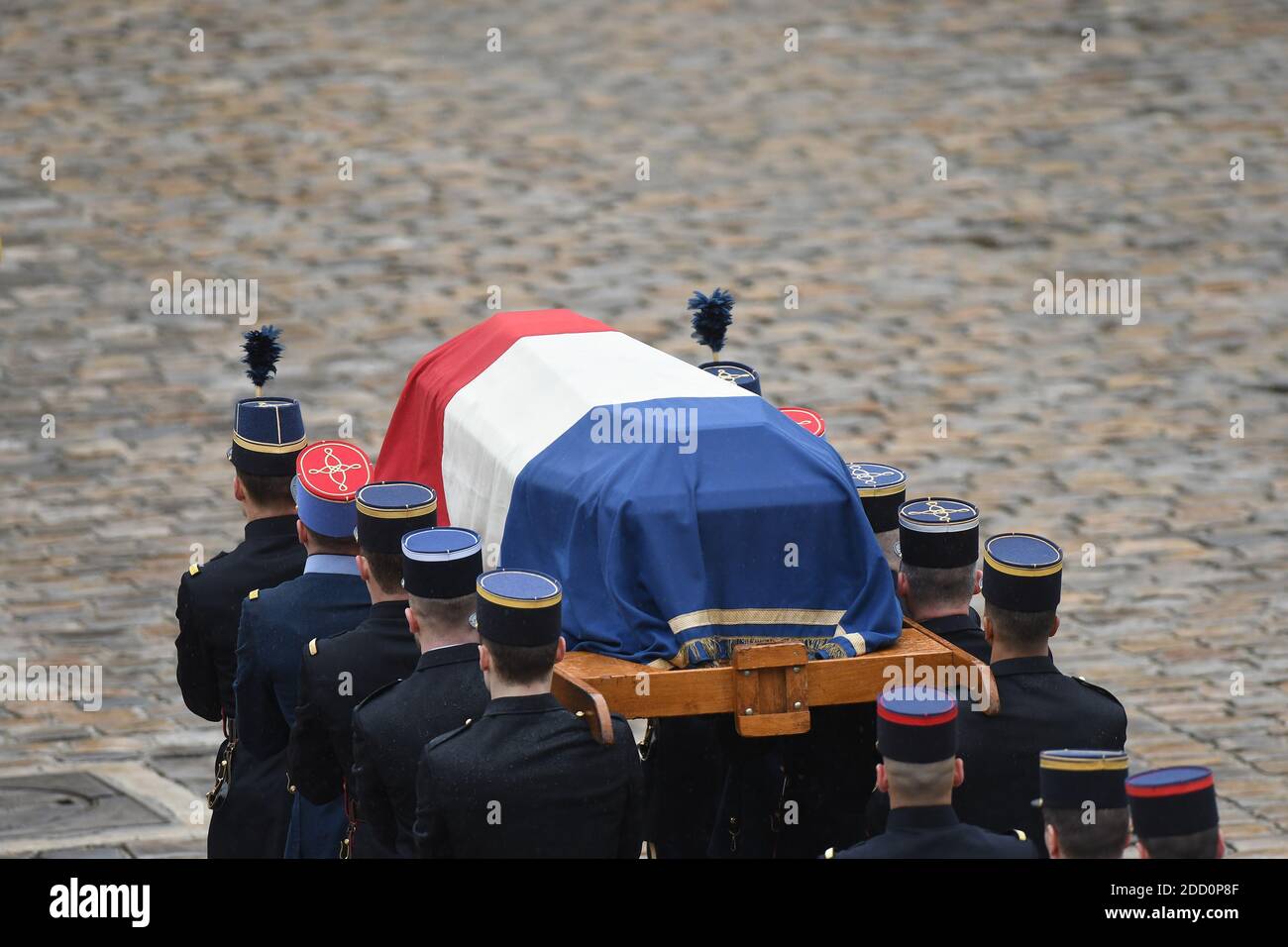French honour guards carry the flag-draped coffin of Gendarmerie ...