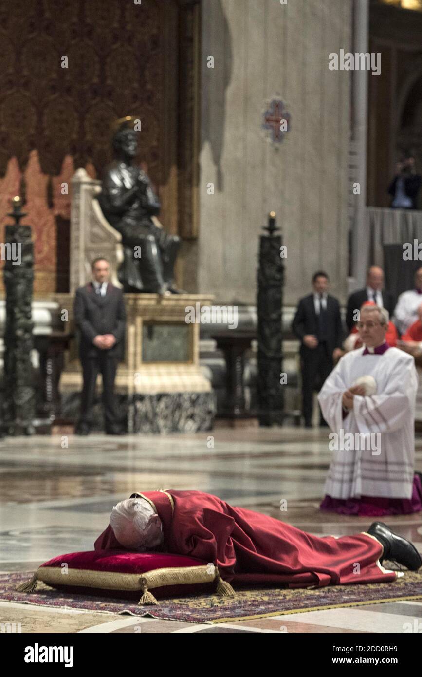 Pope Francis lies down in prayer during the Passion of Christ Mass on ...