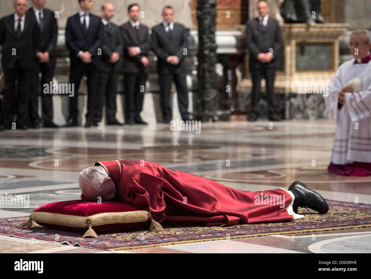 Pope Francis lies down in prayer during the Passion of Christ Mass on ...