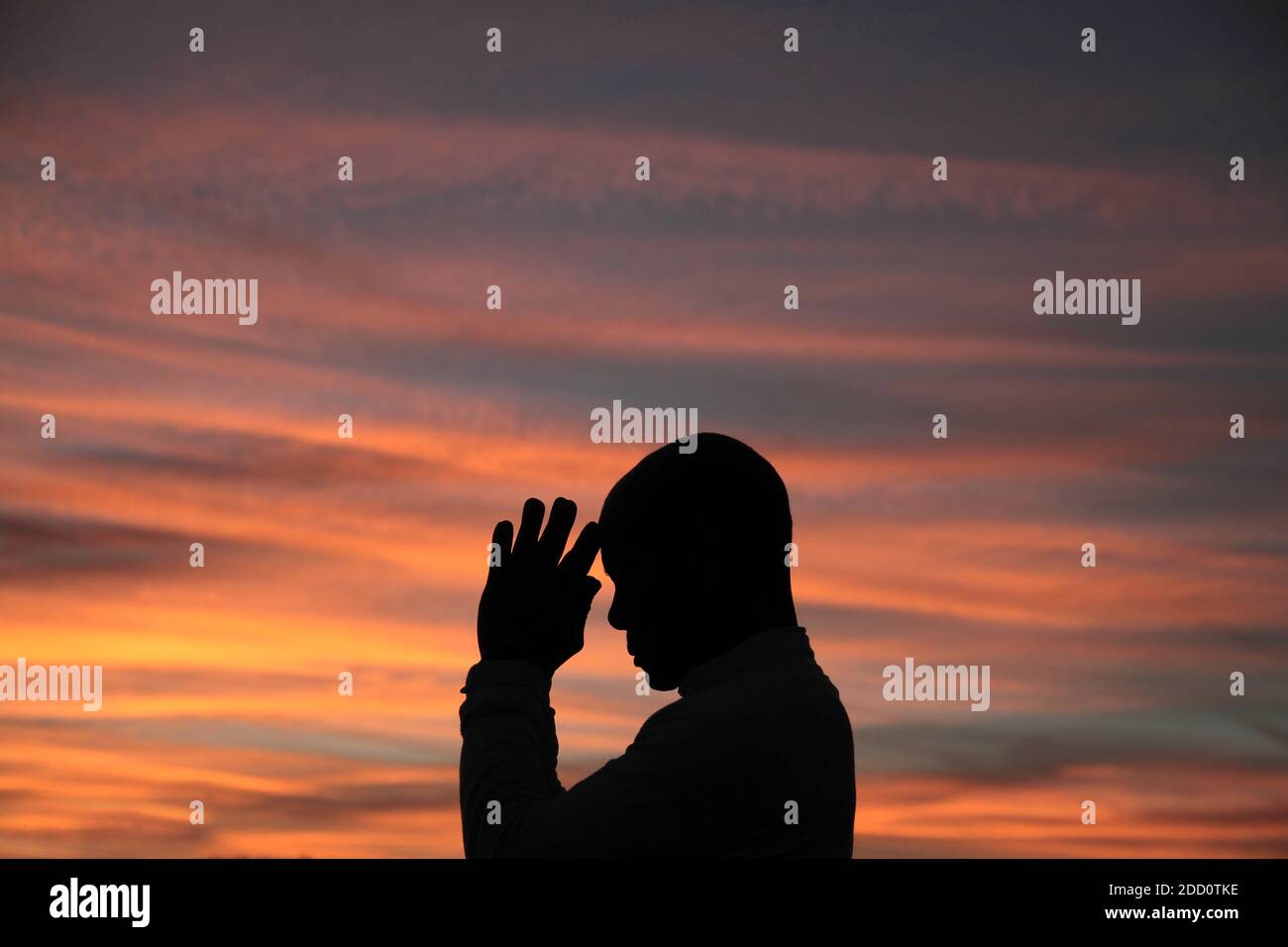 man praying to god with arms outstretched in the sky sunset stock photo ...