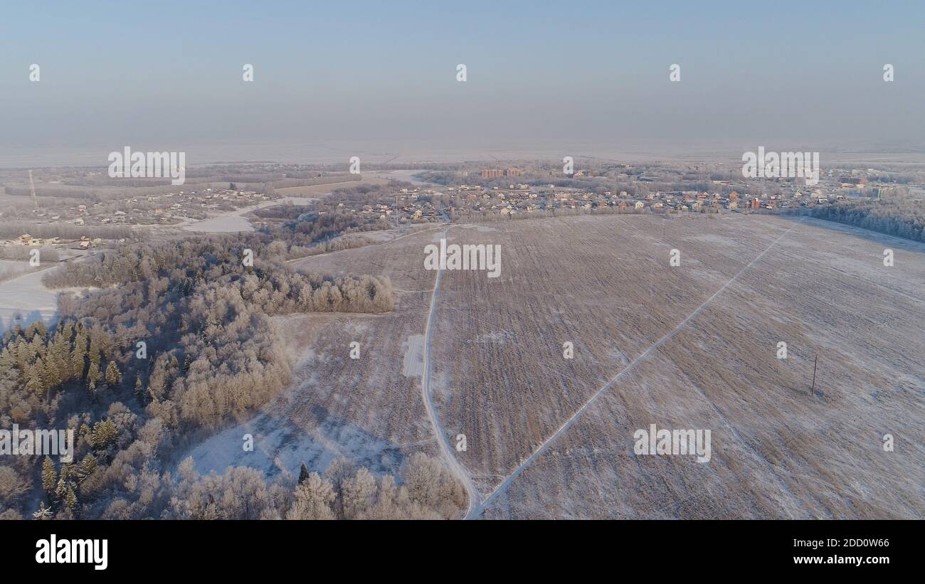 aerial view winter landscape snow covered field and trees, town with ...