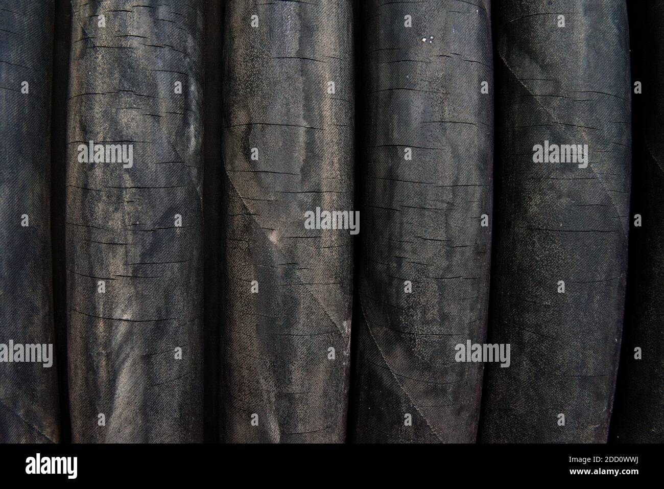 Cracked worn rubber hoses in a coil. Close-up Stock Photo - Alamy