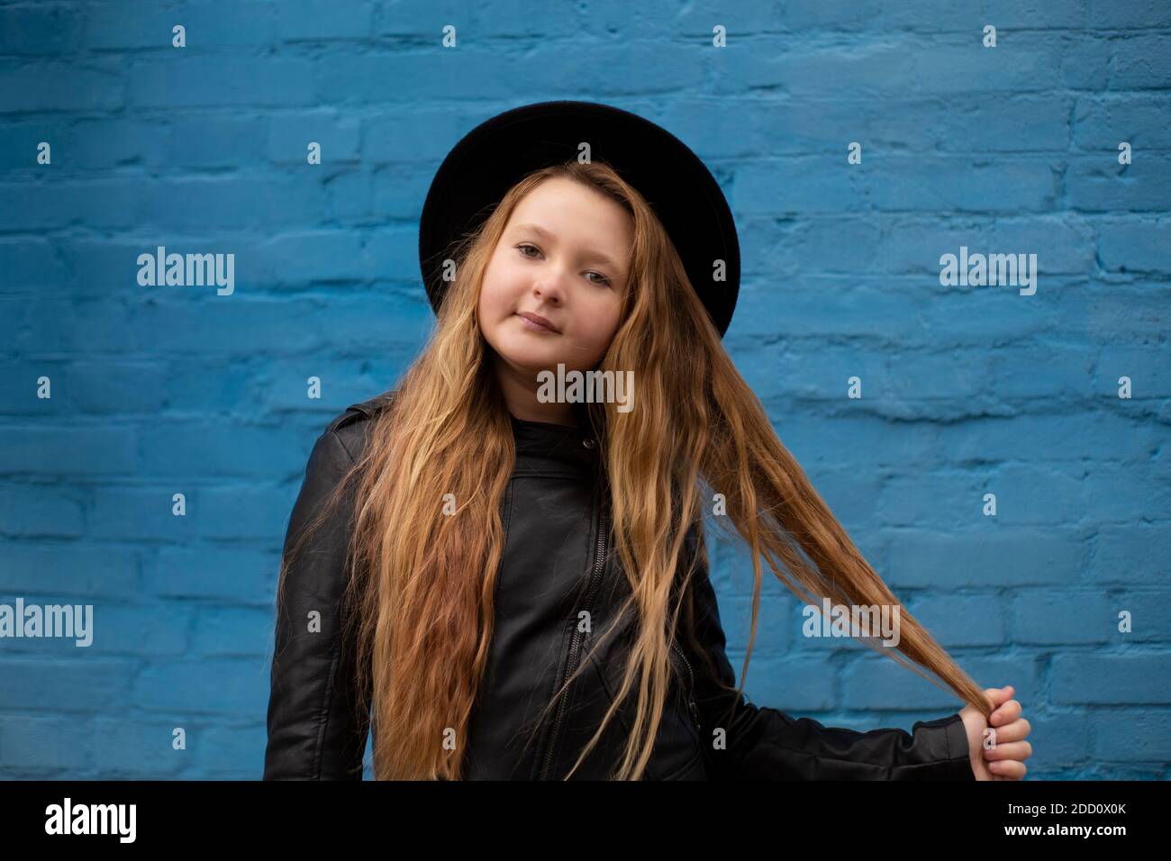 portrait of cute brunette teen girl in Leather Jacket and black hat ...