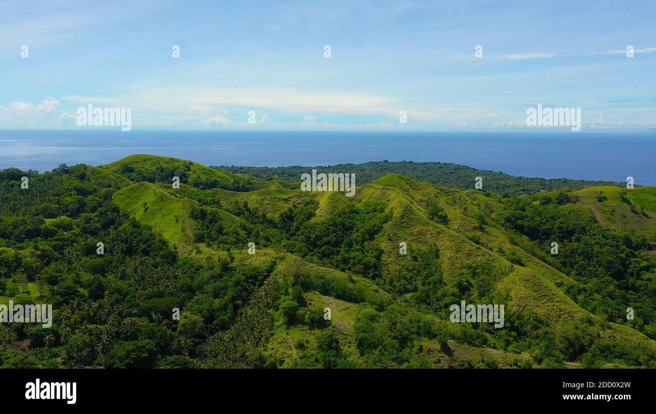 Hills and mountains covered with green grass against a background of ...