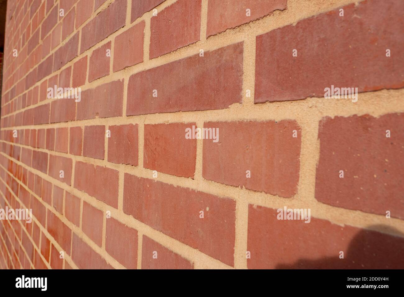 Brick wall in red in the sun Stock Photo - Alamy