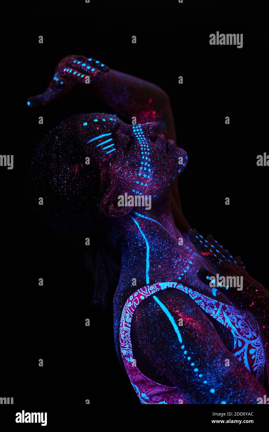 Art woman cosmos in ultraviolet light. Entire body is covered with ...