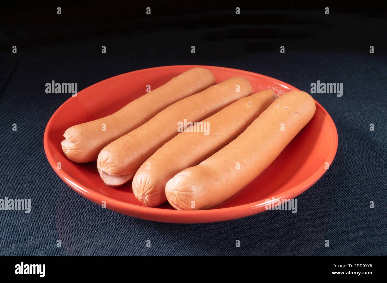 The Hot dogs on table in red plate on black background. The Products of ...