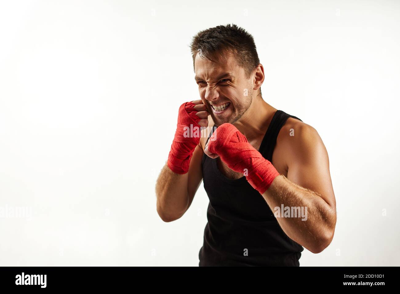 sporty man in red sports bandages on his hands fighting isolated on ...