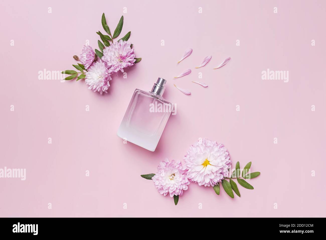 A bottle of perfume, flowers and petals on pink background Stock Photo ...