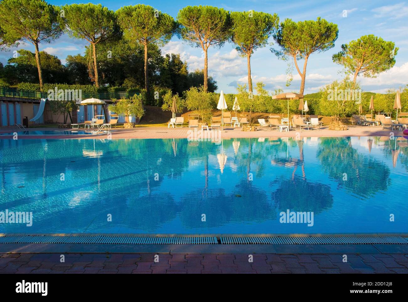 An empty hotel swimming pool in Tuscany, Italy, in the late afternoon ...