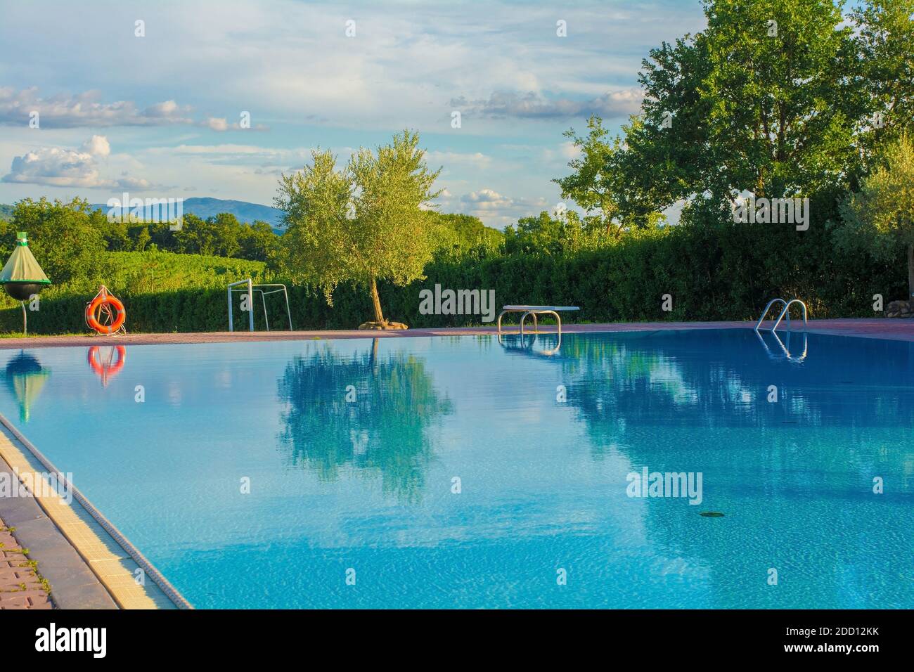 An empty hotel swimming pool in Tuscany, Italy, in the late afternoon ...