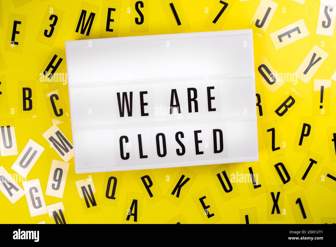 We Are Closed message on lightbox, scattered alphabet letters on ...