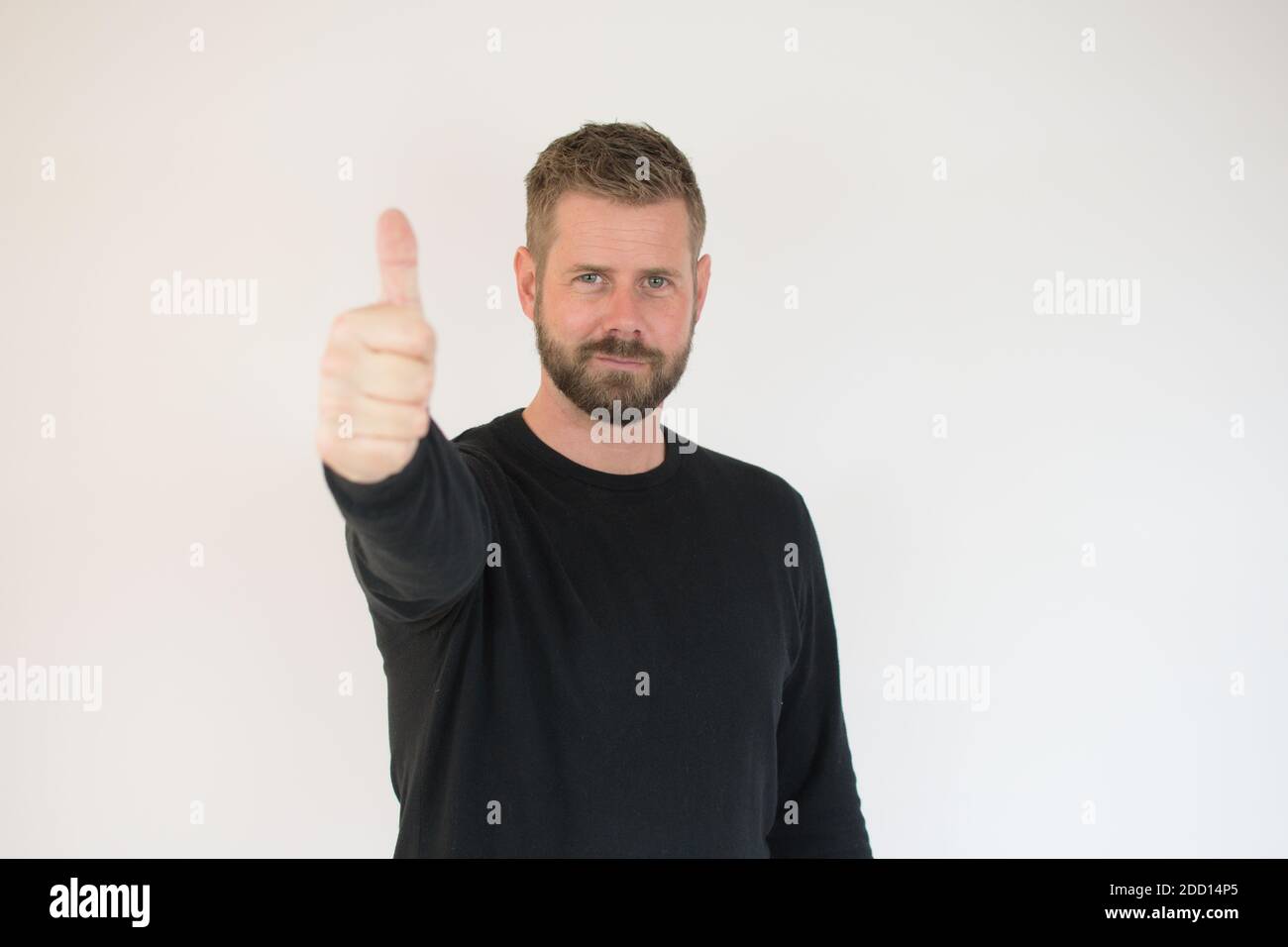 Happy handsome man showing thumb up over white background Stock Photo ...