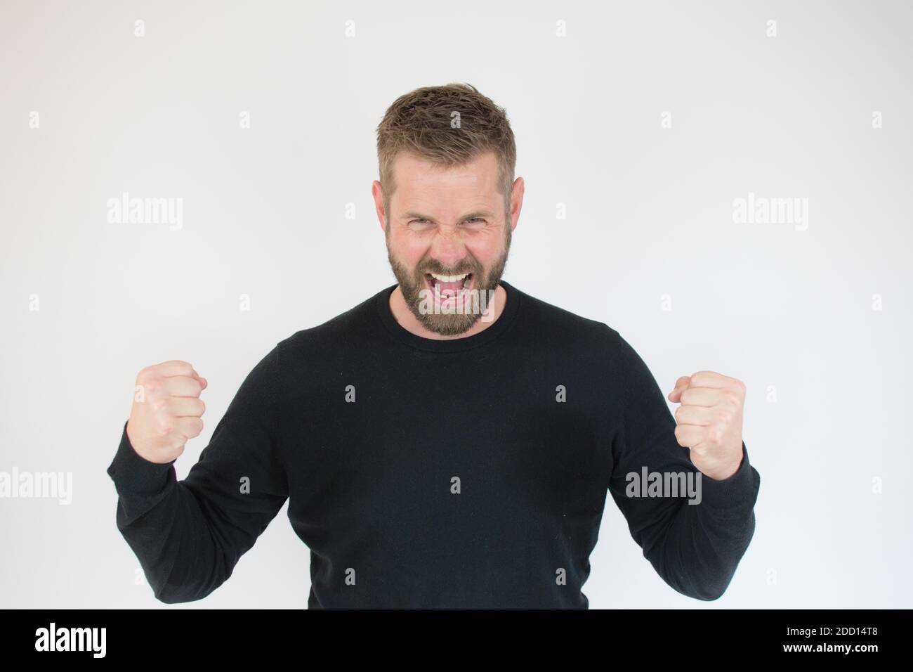 Happy winner. Happy young handsome man gesturing and keeping mouth open ...