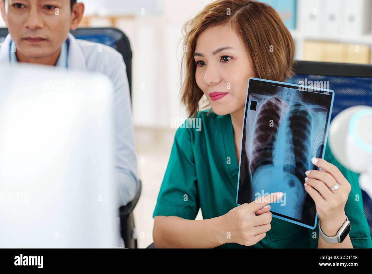 Surgeon video calling coworker Stock Photo - Alamy