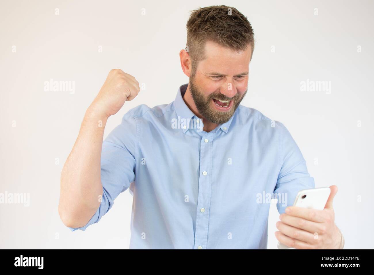 Happy winner. Happy young handsome man gesturing and keeping mouth open ...