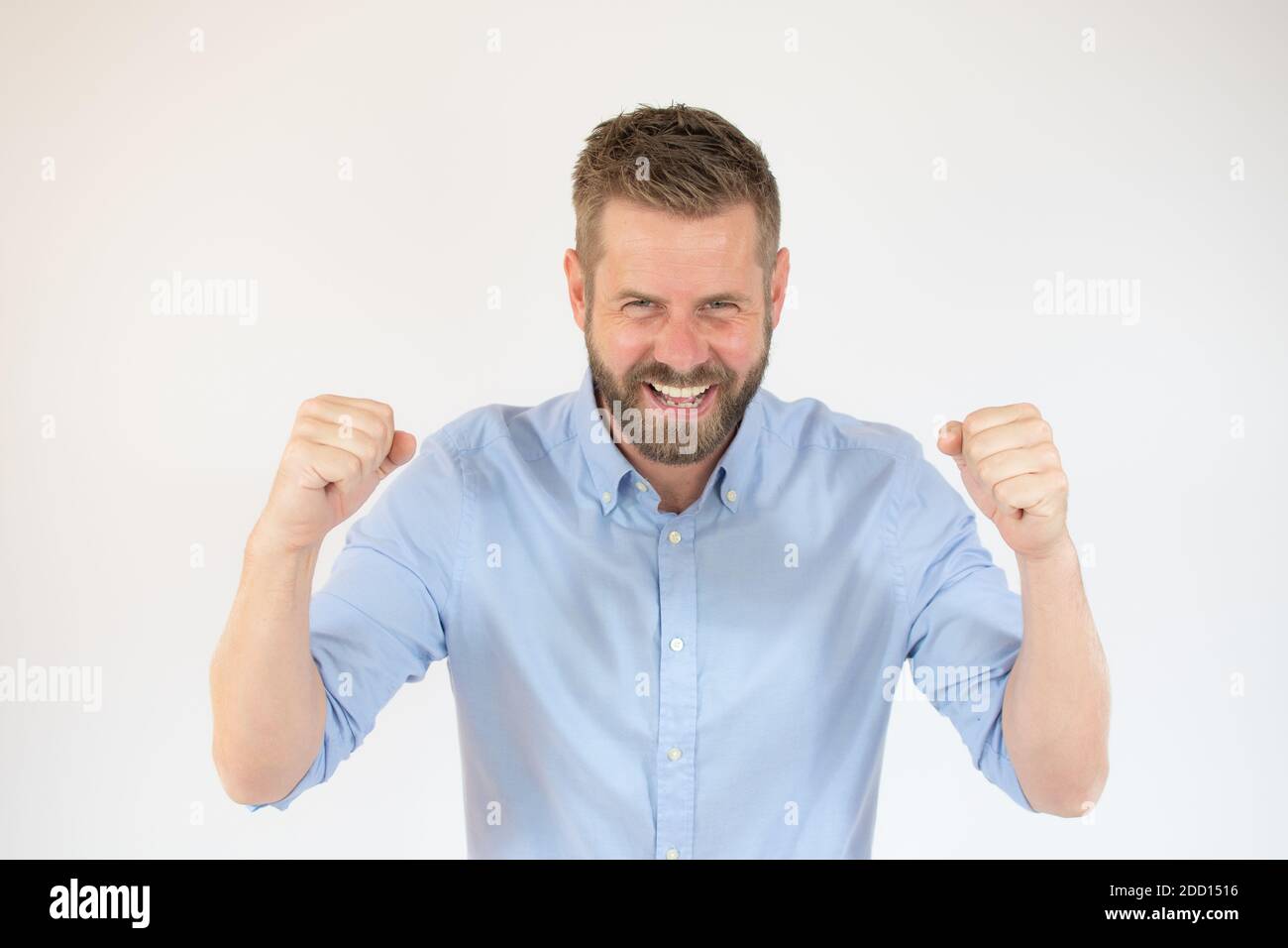 Happy winner. Happy young handsome man gesturing and keeping mouth open ...