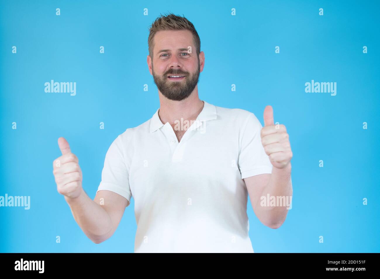 Happy handsome man showing thumbs up over blue background Stock Photo ...