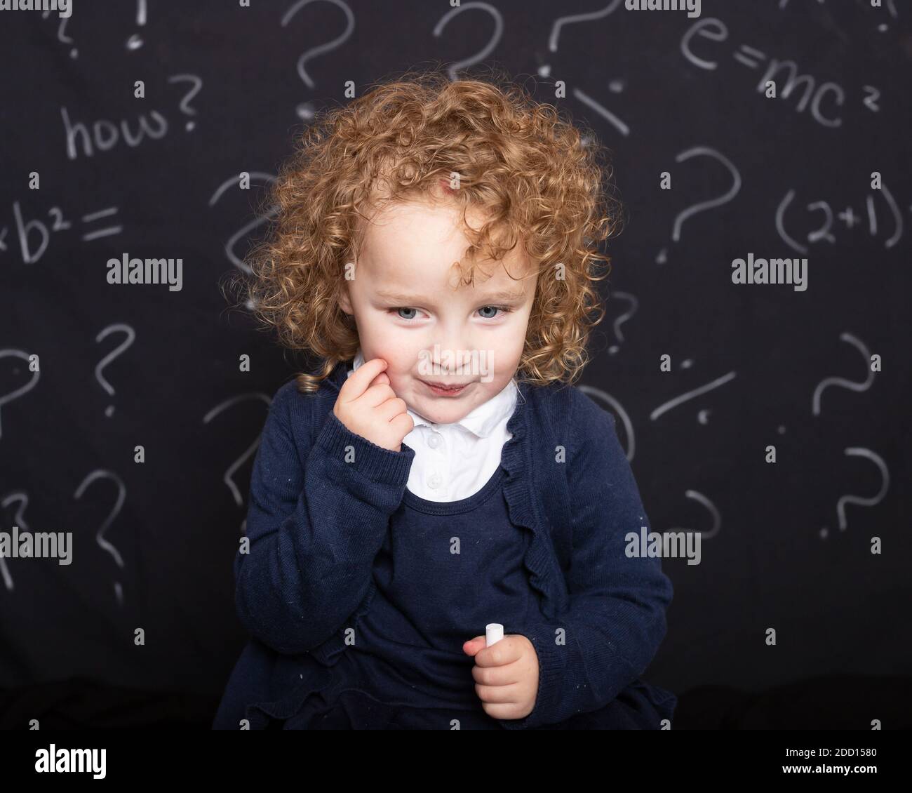 child toddler 3 year old dressed as a teacher and thinking with chalk ...