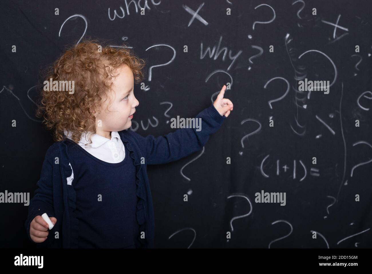 child toddler 3 year old dressed as a teacher and thinking with chalk ...