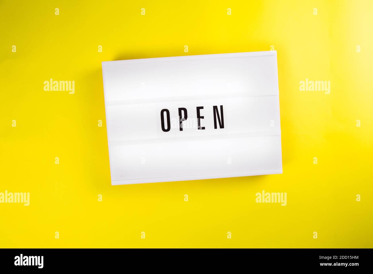 Open word on lightbox on yellow background isolated Stock Photo - Alamy