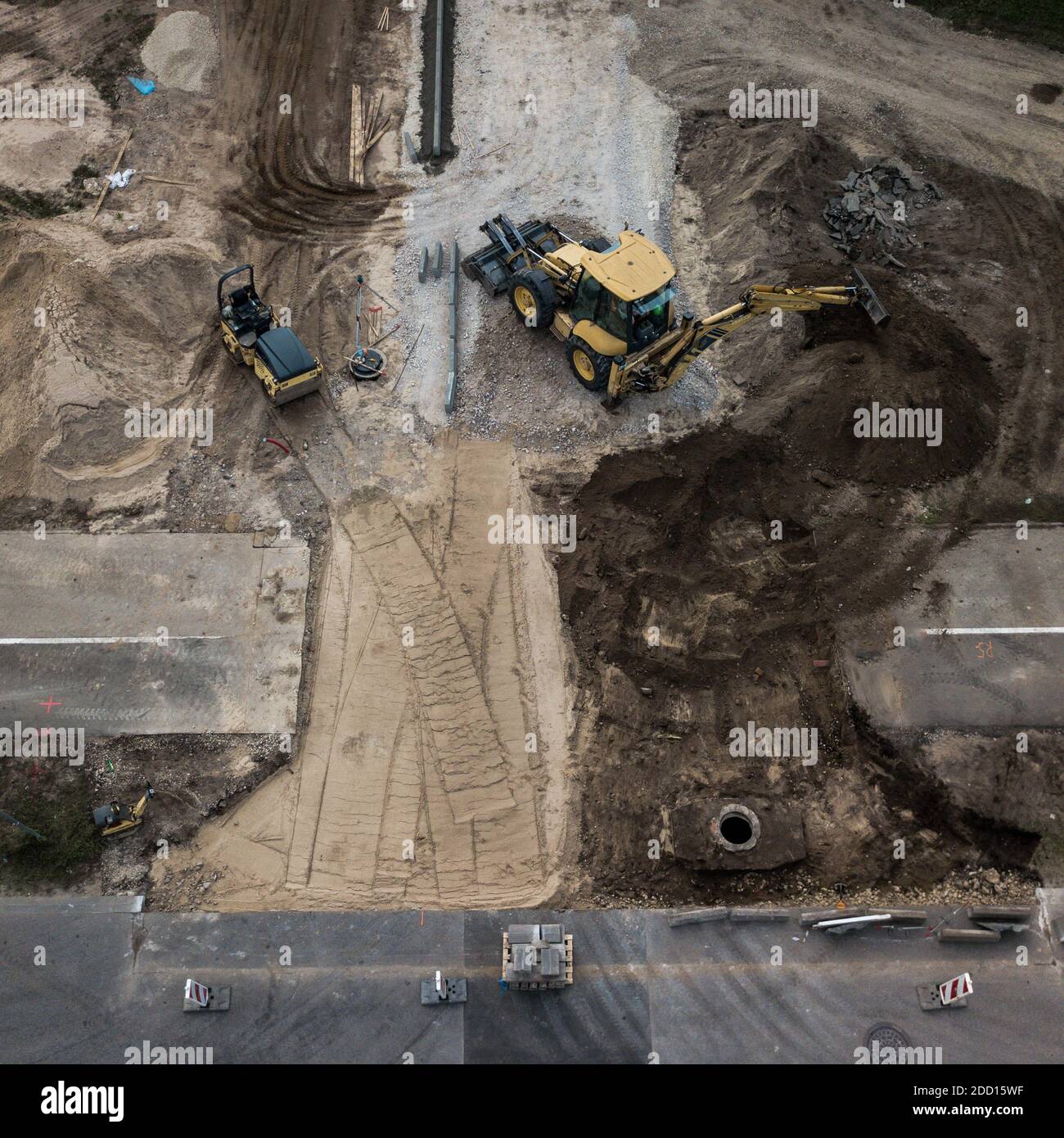 View from above of road construction works. Heavy equipment. Yellow ...