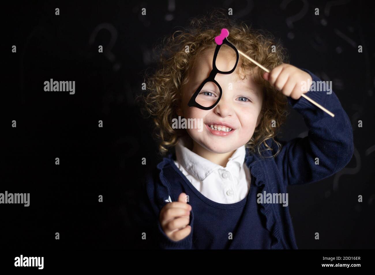 child toddler 3 year old dressed as a teacher and thinking with chalk ...