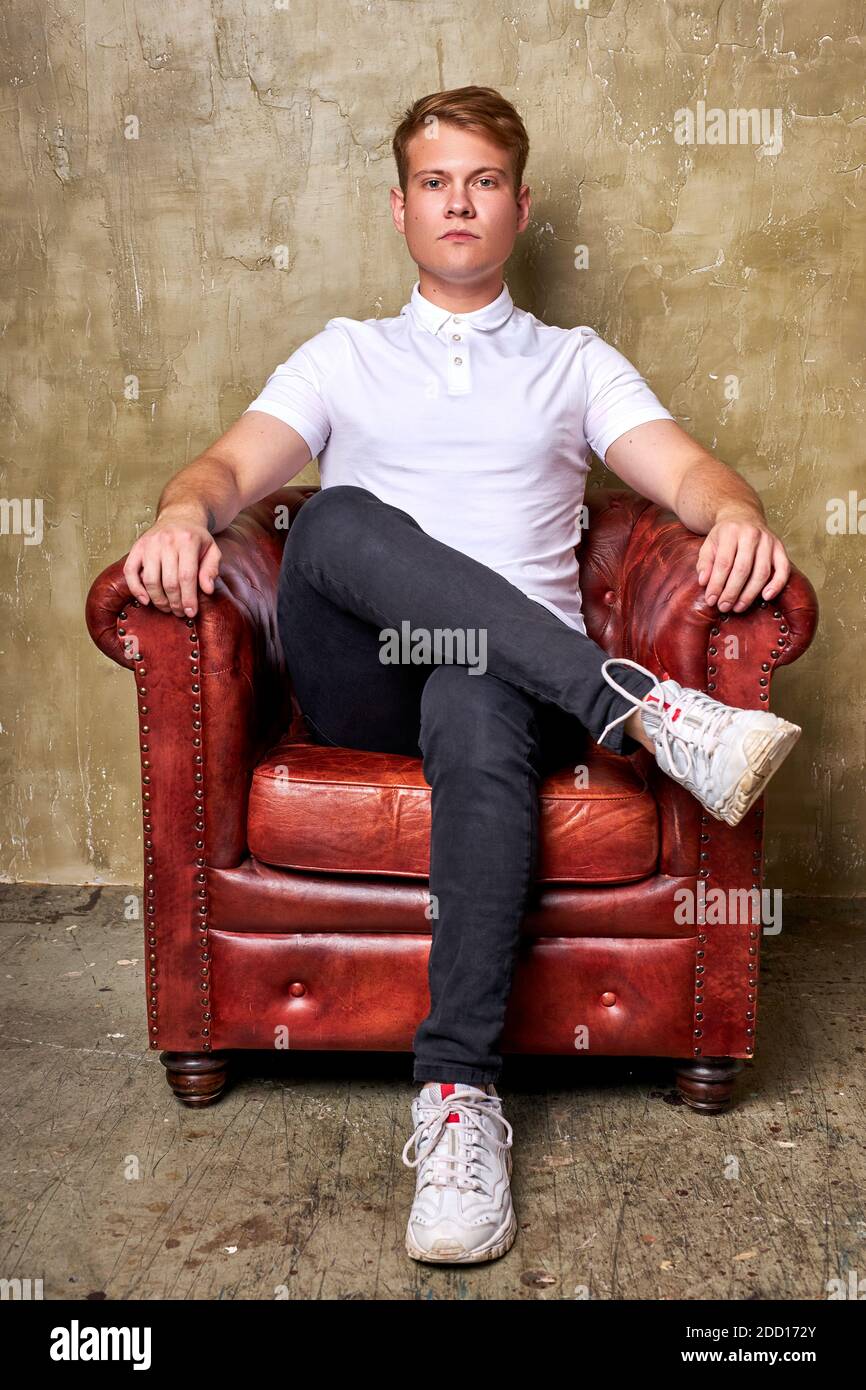 portrait of bossy caucasian man on leather chair sofa or couch, sit ...