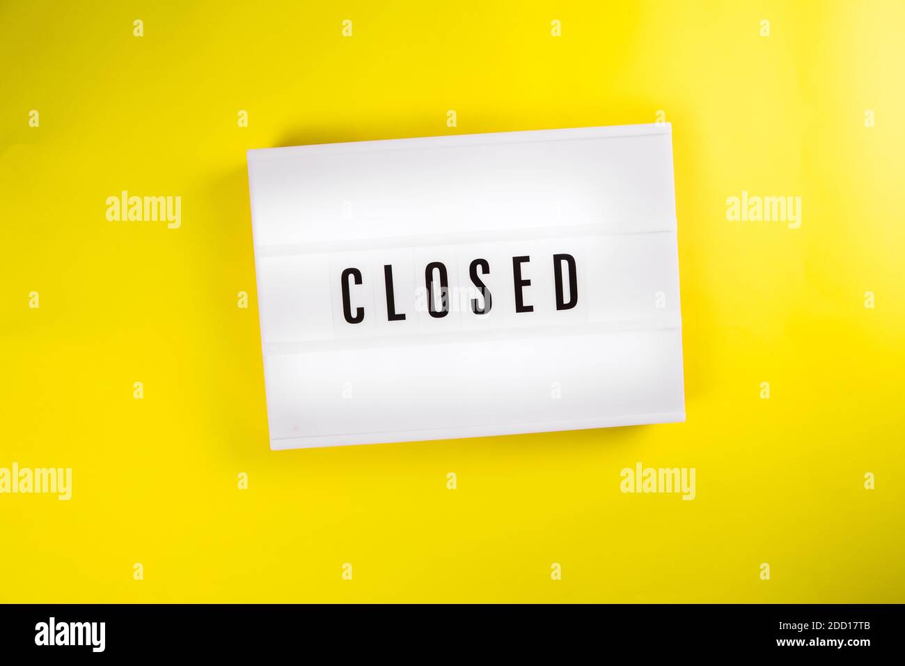 Closed word on lightbox, vintage billboard on yellow background ...