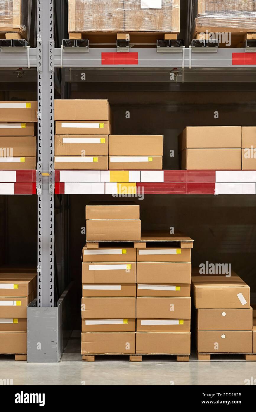 Warehouse stocked with boxes in stacks Stock Photo - Alamy