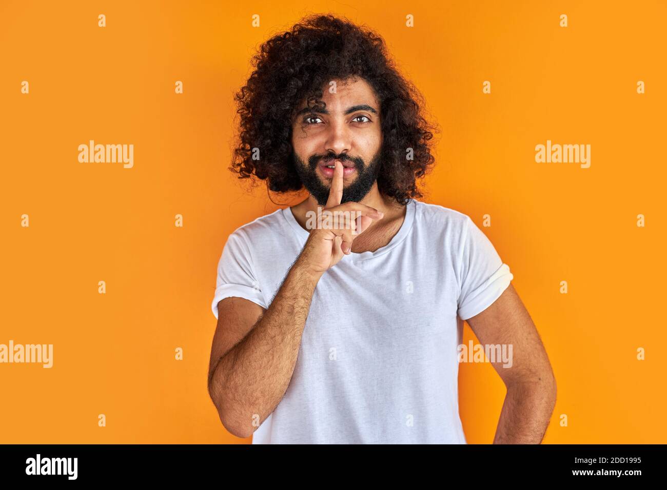 indian arabic male asking to be quiet with finger on lips, silence and ...