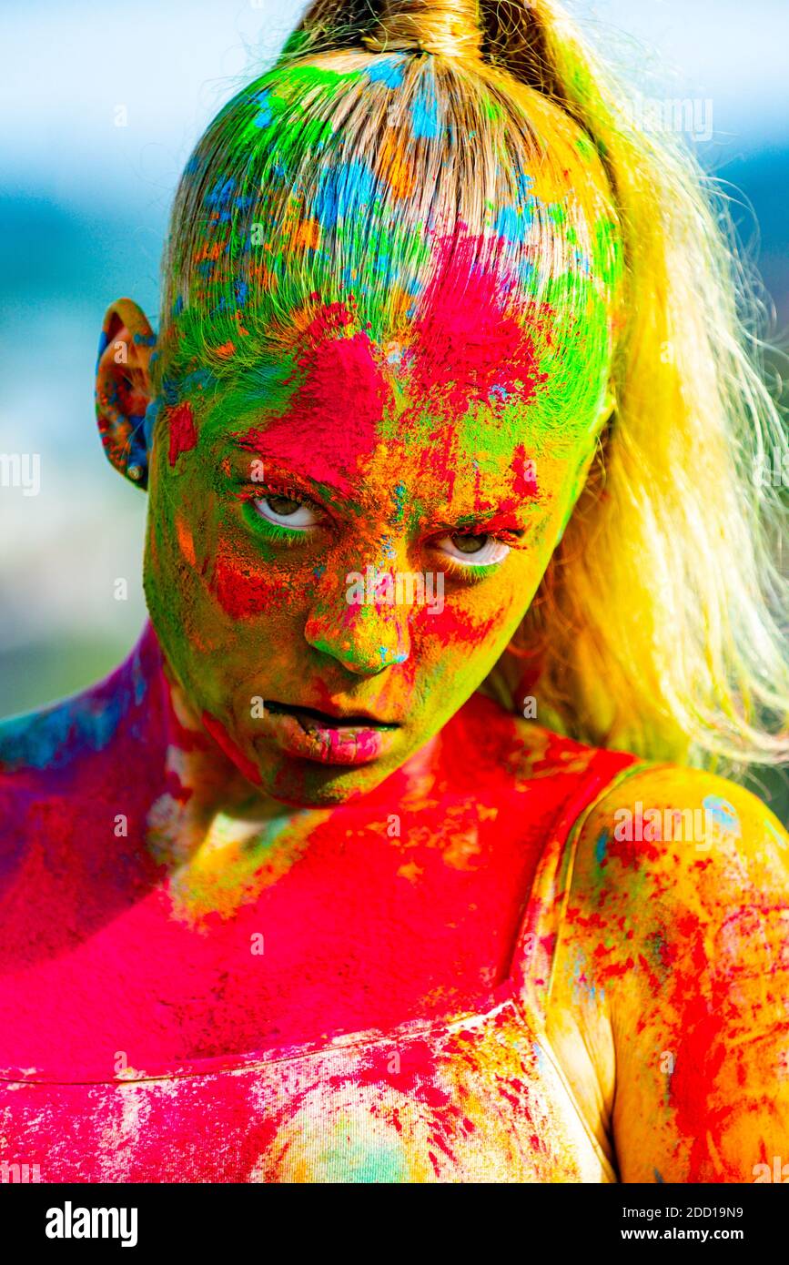 Holi powder on face. Color face with colorful splash Stock Photo - Alamy