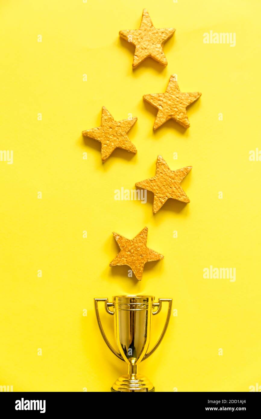 Simply flat lay design winner or champion gold trophy cup and 5 stars ...