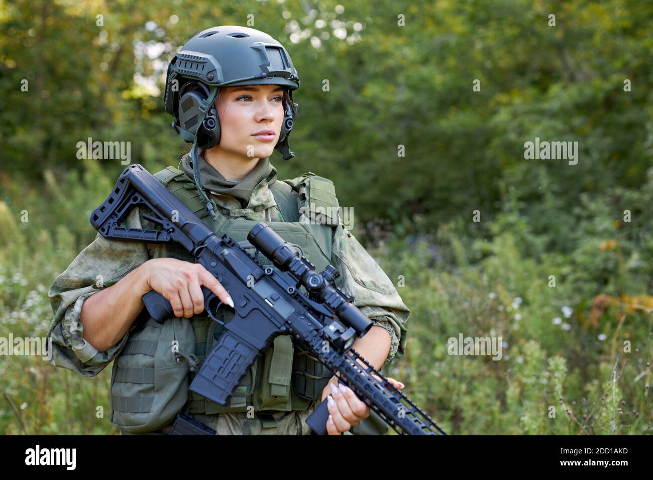 strong brave female army soldier with rifle machine gun standing in the ...