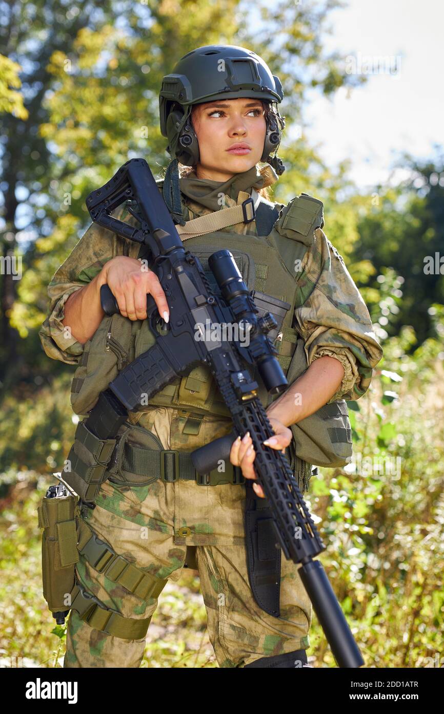 strong brave female army soldier with rifle machine gun standing in the ...