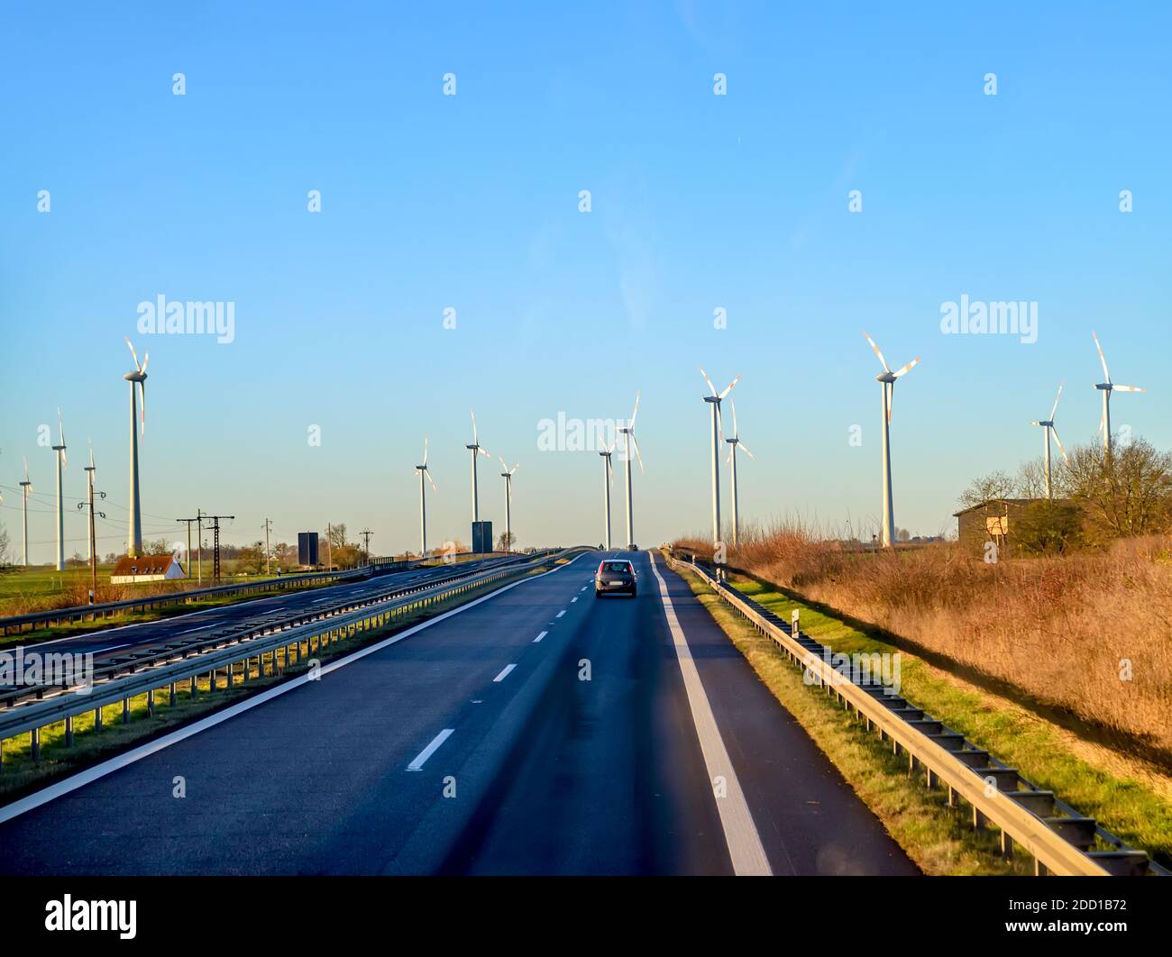 Wind turbines along the roadway Stock Photo - Alamy