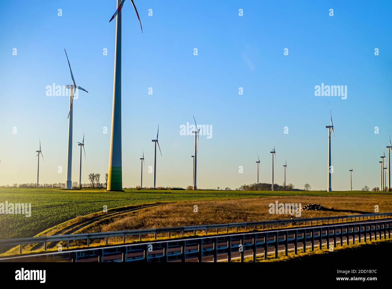 Wind turbines along the roadway Stock Photo - Alamy