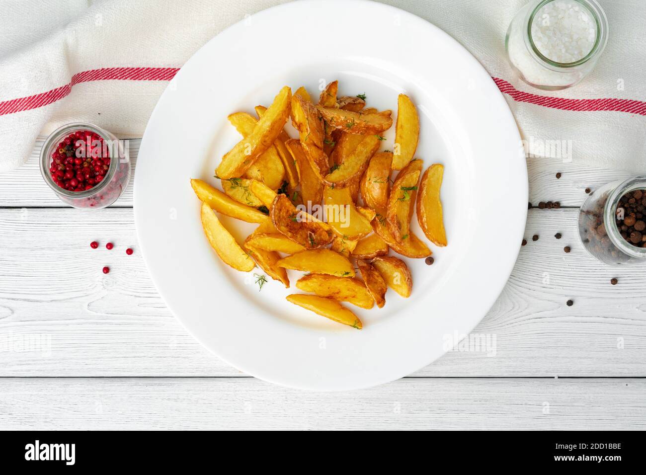 Fried potato wedges in plate on white wooden table Stock Photo - Alamy