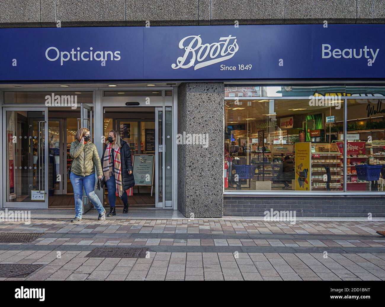 Customers wearing face masks are seen leaving Boots Store Stock Photo ...
